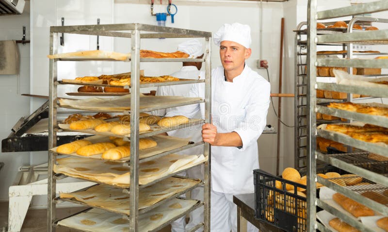 Male Baker Rolling Cart with Bread in Kitchen Stock Image - Image of ...