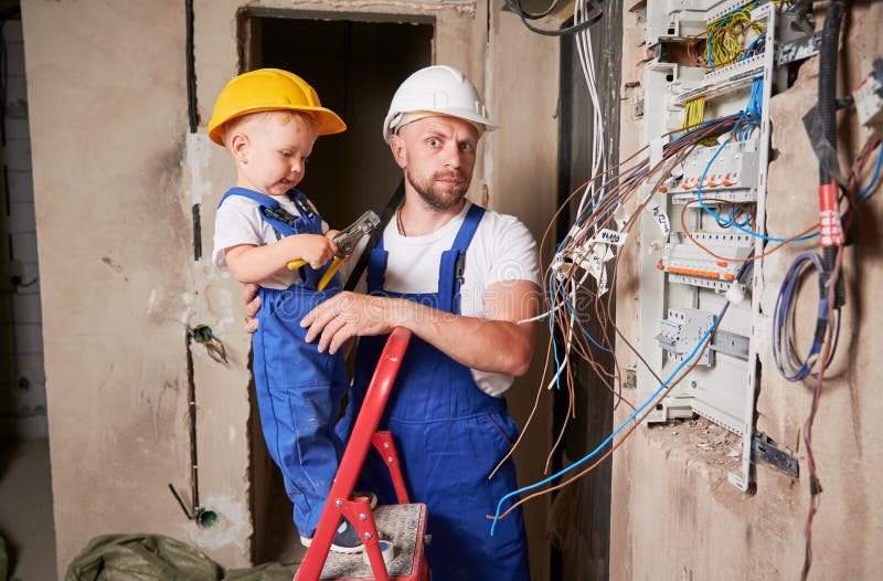 Man and Child Installing Electrical Panel in Apartment. Stock Photo ...