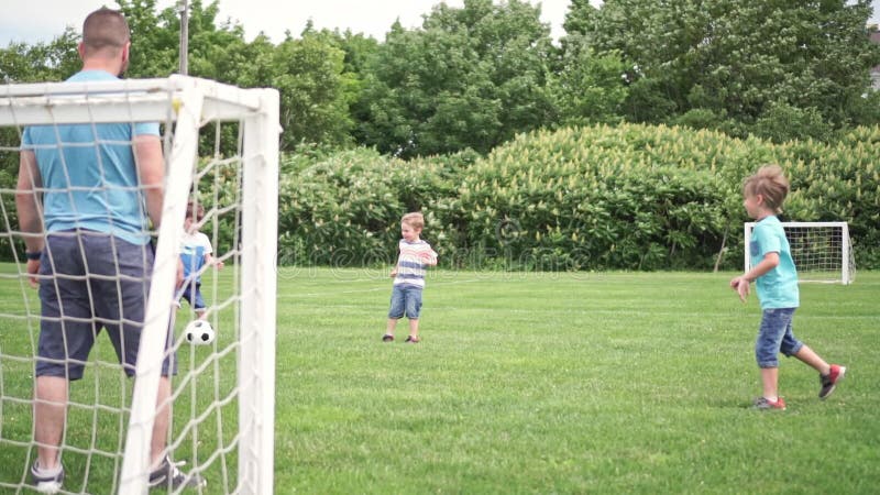 Man with Child Playing Football Outside on Field Stock Footage - Video ...