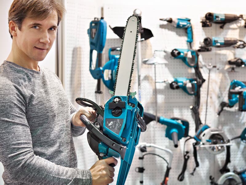 Man chooses chain saw stock image. Image of people, chainsaw - 81266655