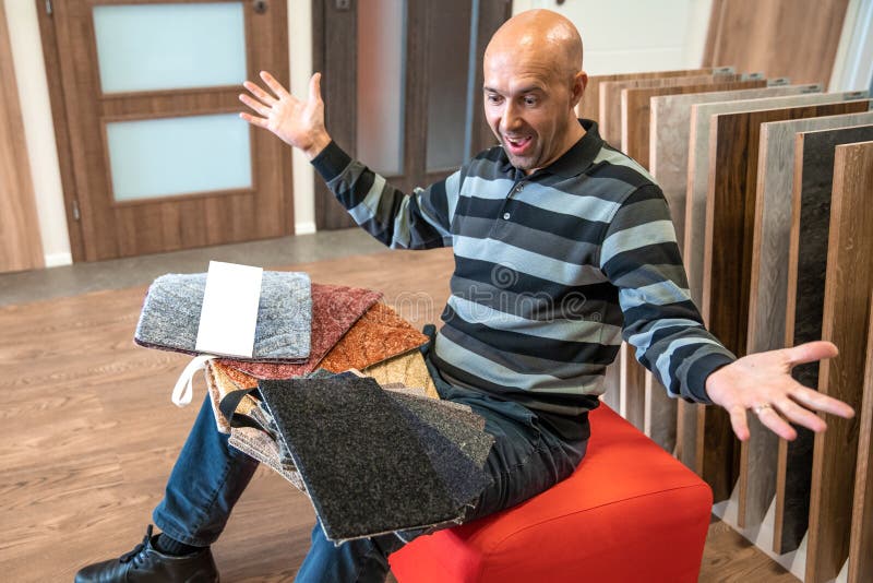 The Man Chooses the Color of the New Carpet According To the Samples in ...