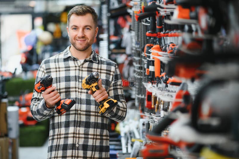 A Man Chooses a Power Tool in a Hardware Store Stock Image - Image of ...