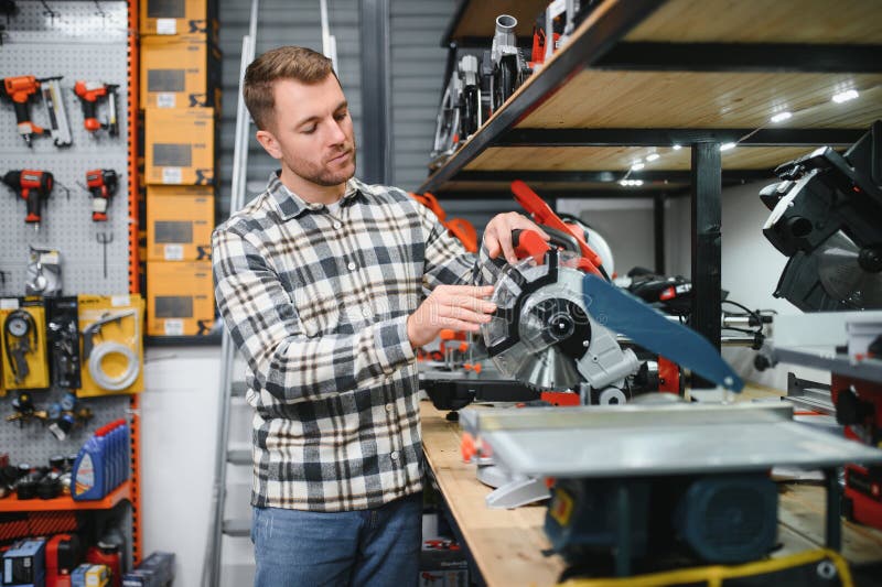 A Man Chooses a Power Tool in a Hardware Store Stock Image - Image of ...