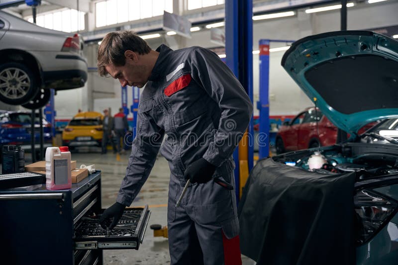 Man Chooses Tools for Car Repair in Workshop Stock Image - Image of ...