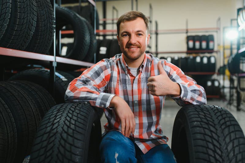 Man Chooses Winter Car Tires in the Auto Shop Stock Photo - Image of ...