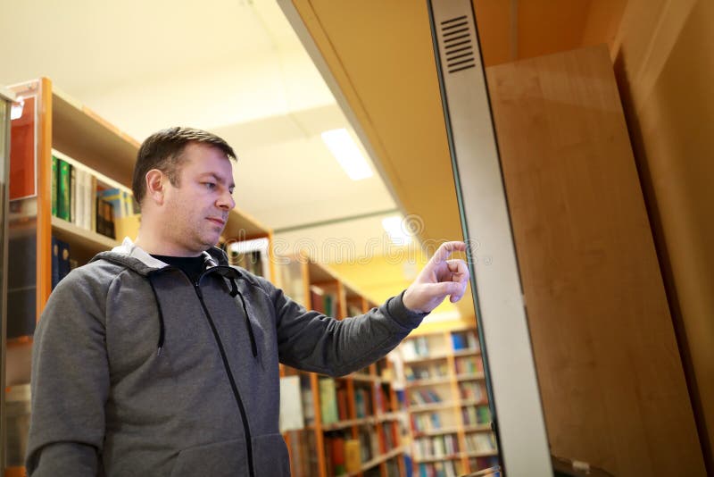 Man Choosing Book Using Touchscreen Stock Image - Image of casual ...