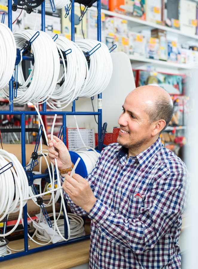 Man Choosing Cable in Household Store Stock Photo - Image of american ...