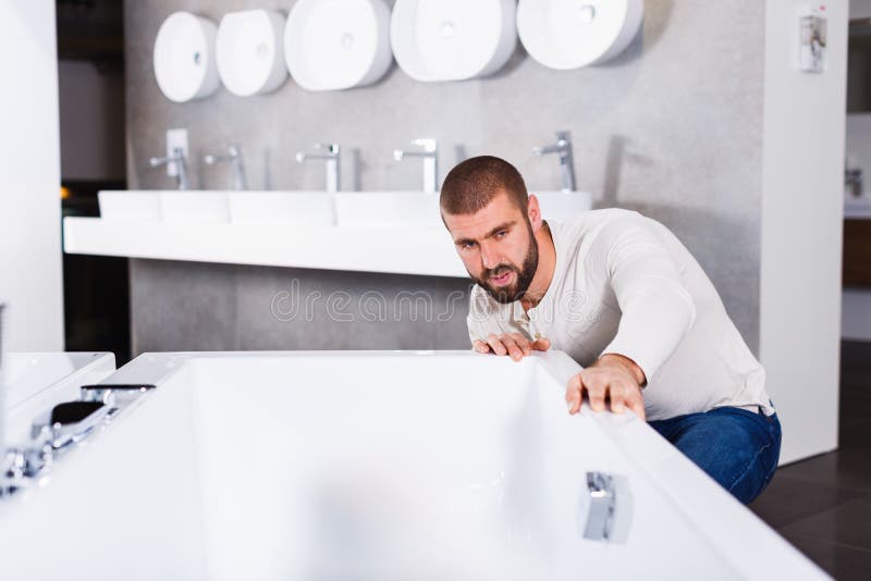 Man Choosing Ceramic Bath in Bathroom Furniture Store Stock Photo ...