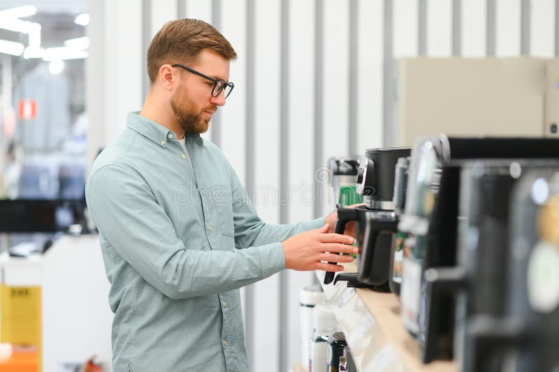 Man Choosing Crockpot at Electric Store Stock Photo - Image of smile ...