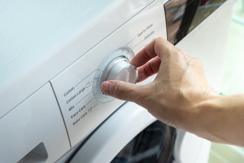 Man Choosing Cycle Program on Washing Machine. Stock Photo - Image of ...