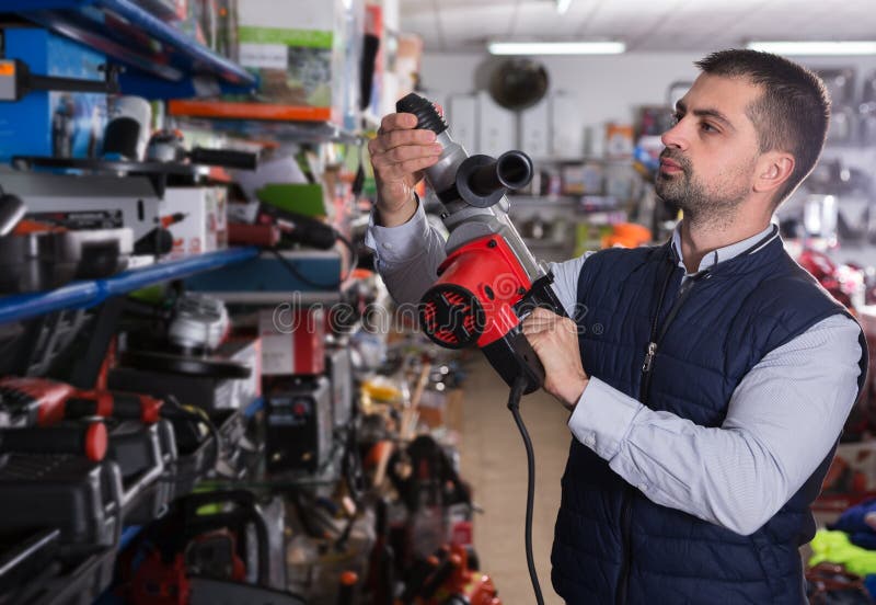 Man Choosing Drilling Machine Stock Image - Image of retail, casual ...