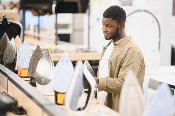 Man Choosing Electric Iron at Store Stock Photo - Image of modern ...