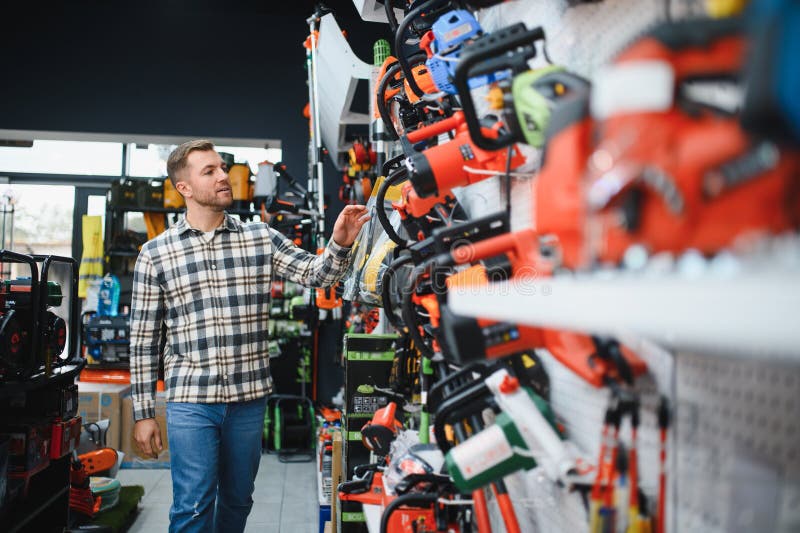 Man is Choosing Electric Saw in Tools Store Stock Image - Image of ...