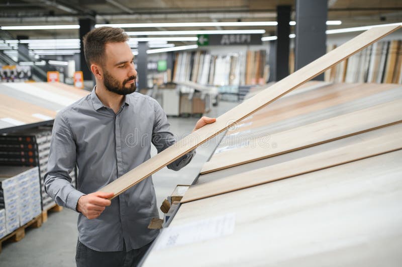 Man Choosing Laminate Samples in Hardware Store Stock Image - Image of ...
