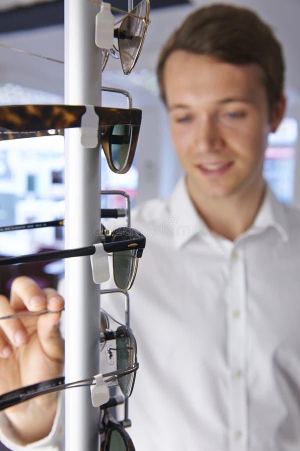 Man Choosing Sunglasses in Opticians Stock Image - Image of people ...