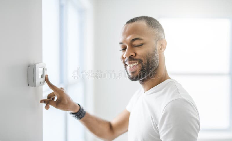 Man Choosing Temperature on Thermostat. Young Focused Guy Pushing ...