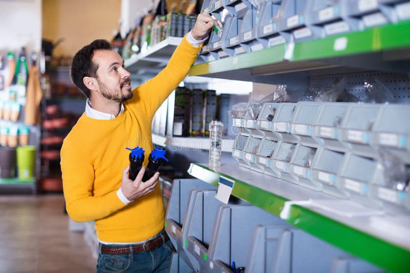 Man Choosing Various Tools in Garden Equipment Shop Stock Image - Image ...