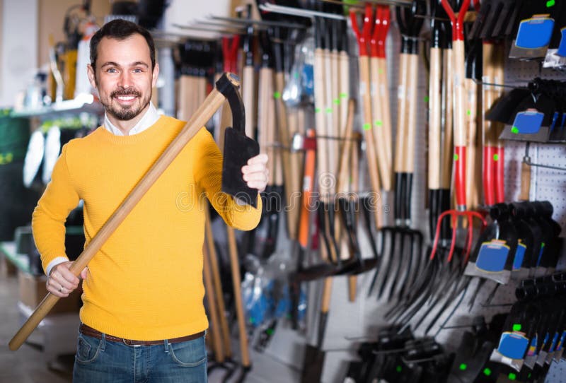 Man Choosing Various Tools in Garden Equipment Shop Stock Photo - Image ...