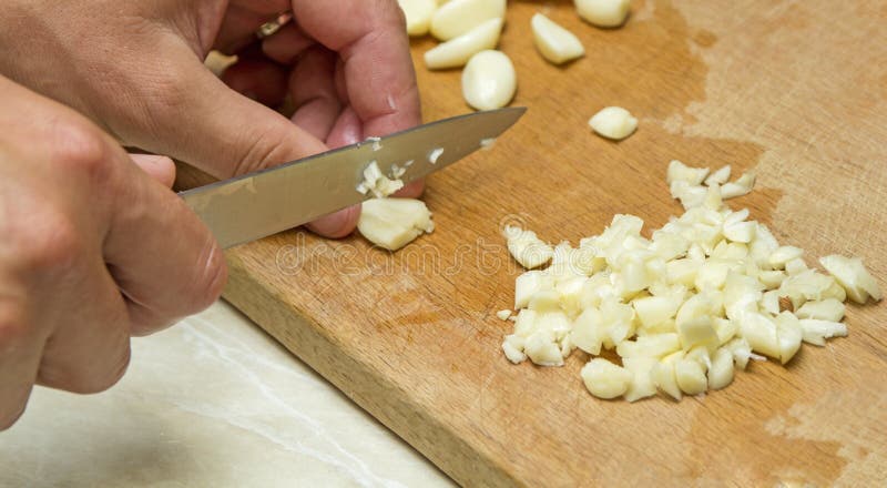 Man chopping the garlic stock photo. Image of vegetable - 32396324