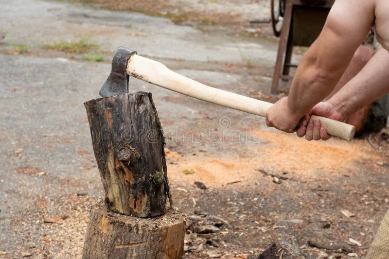 A Man Chops Firewood with a Large Axe in the Summertime Stock Photo ...