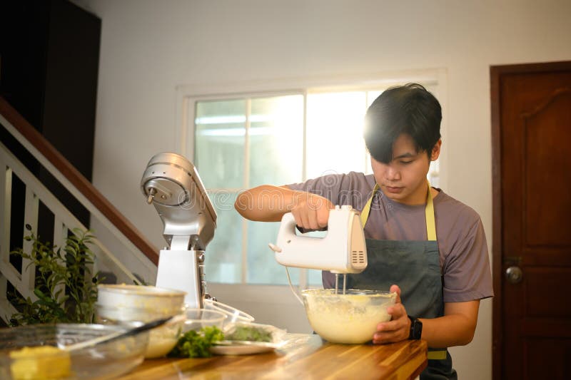 Man Churning Cream into Butter with an Electric Mixer in a Modern ...