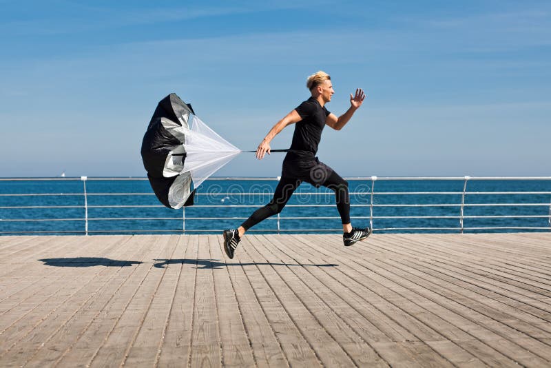 Man with Chute Running on Pier Stock Photo - Image of wellness, running ...