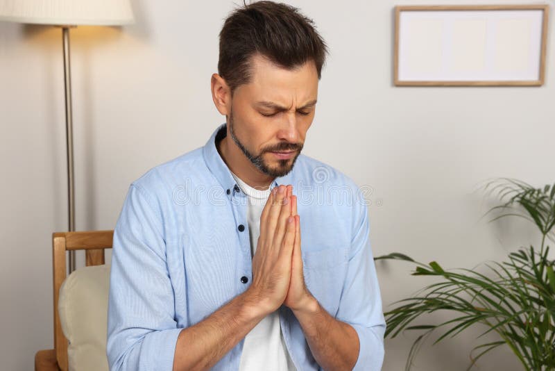Man with Clasped Hands Praying in Room at Home Stock Photo - Image of ...