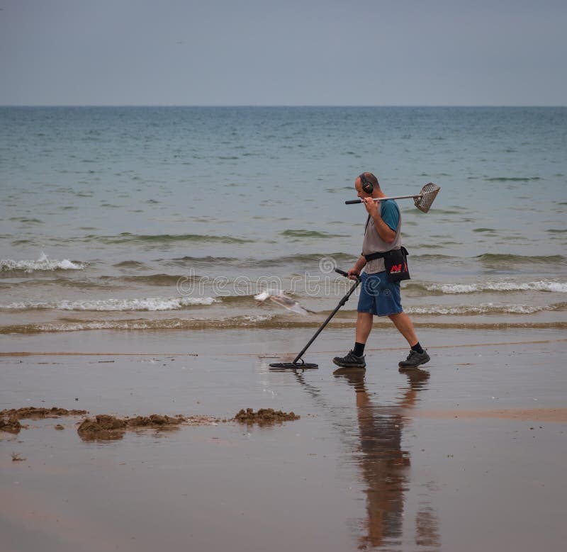 Man Cleaning Beach with Electronic Beach Device and Sand Cleaning Tool ...