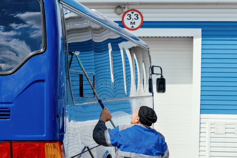 A Man is Cleaning a Bus with a Squeegee Stock Image - Image of male ...