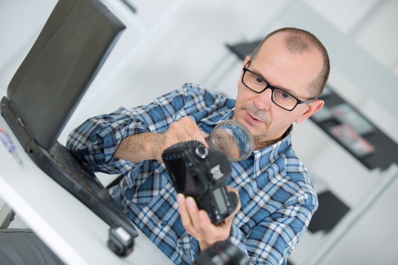 Man cleaning camera lens stock image. Image of caucasian - 103742415