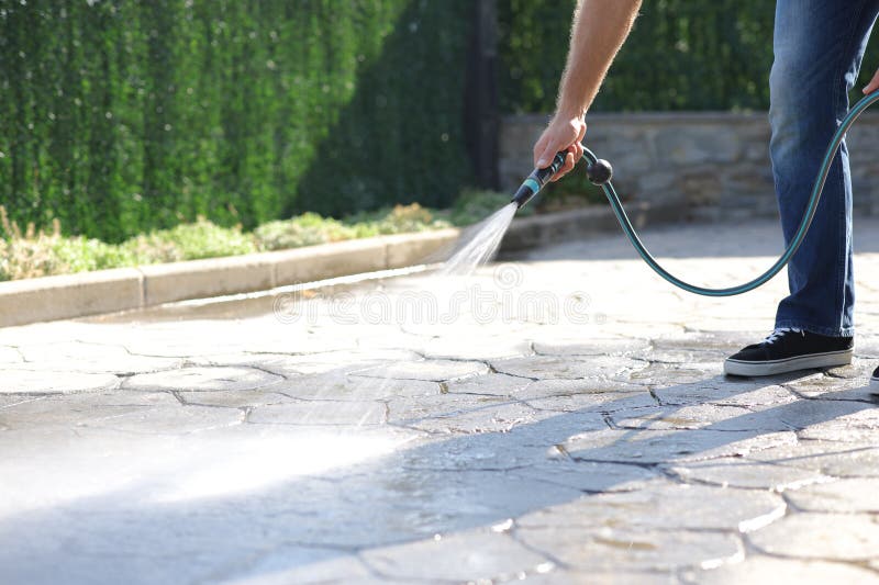 Man Cleaning Garden Floor with Water Using Hosepipe Stock Image - Image ...