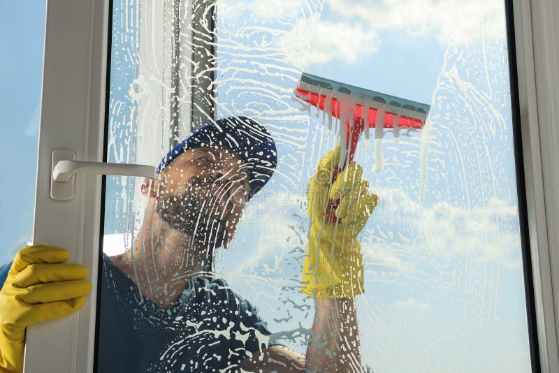 Man Cleaning Glass with Squeegee Indoors, View from Inside Stock Image ...