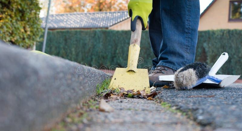 Man is cleaning the gutter stock image. Image of ground - 130744489