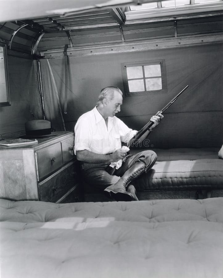 Man cleaning his rifle stock image. Image of black, hunting - 59792337