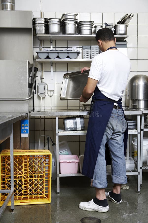 Man cleaning the kitchen stock photo. Image of employee - 7789874