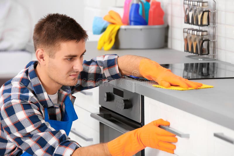 Man Cleaning Kitchen Counter with Rag Stock Photo - Image of background ...