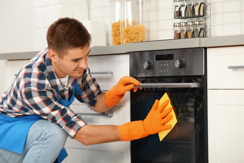 Man Cleaning Kitchen Oven with Rag Stock Image - Image of housework ...