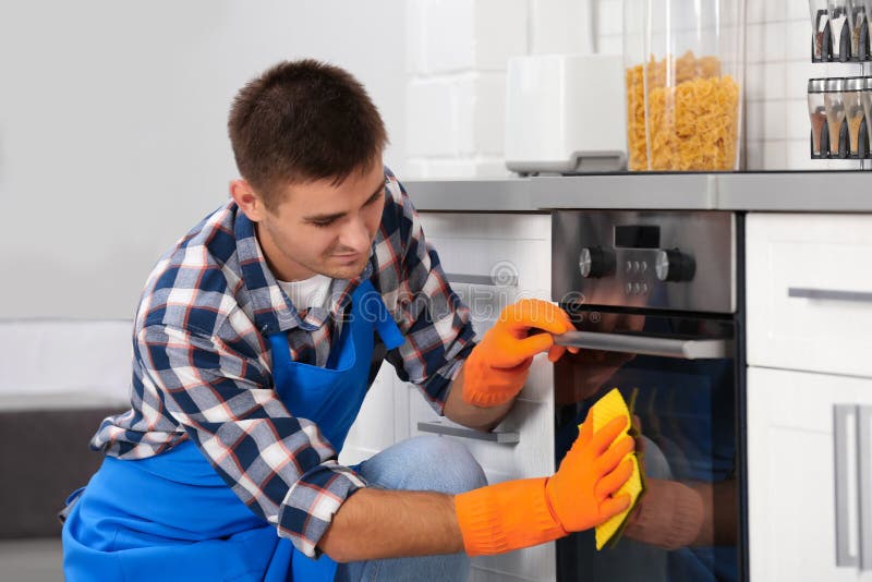 Man Cleaning Kitchen Oven with Rag Stock Photo - Image of company ...