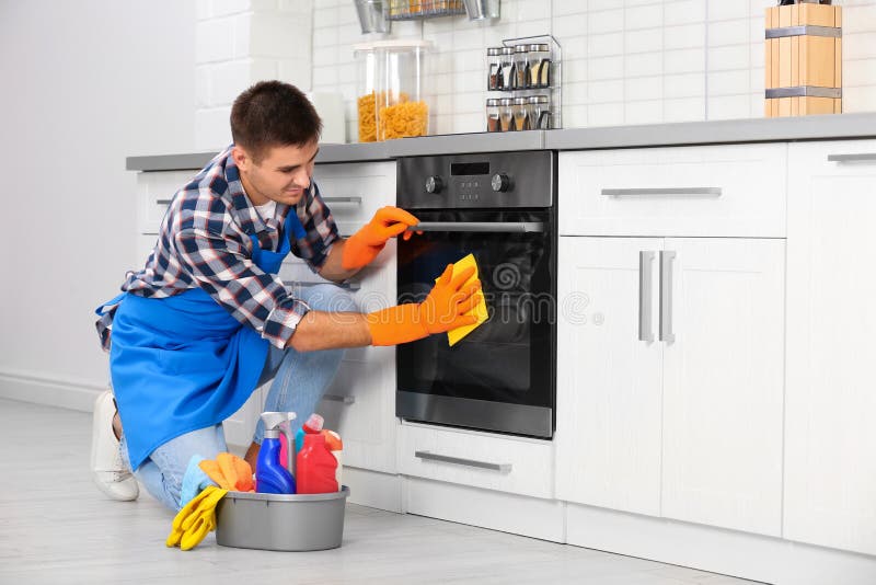 Man Cleaning Kitchen Oven with Rag Stock Photo - Image of male ...