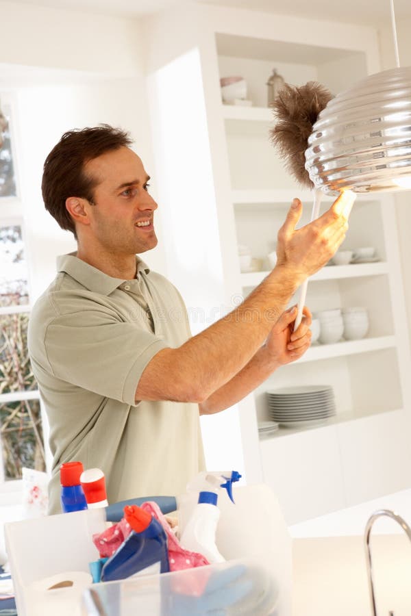 Man Cleaning Light Fitting with Feather Duster Stock Photo - Image of ...