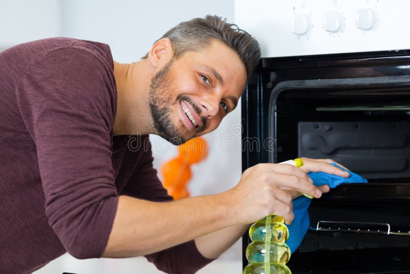 Man Cleaning Oven in Kitchen Stock Photo - Image of clean, cleaner ...