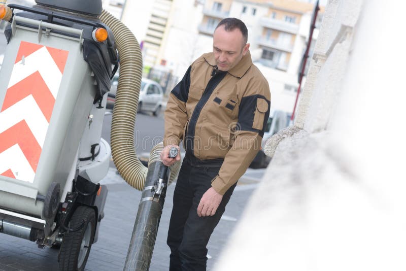 Man cleaning the sidewalk stock photo. Image of vehicle - 118899236