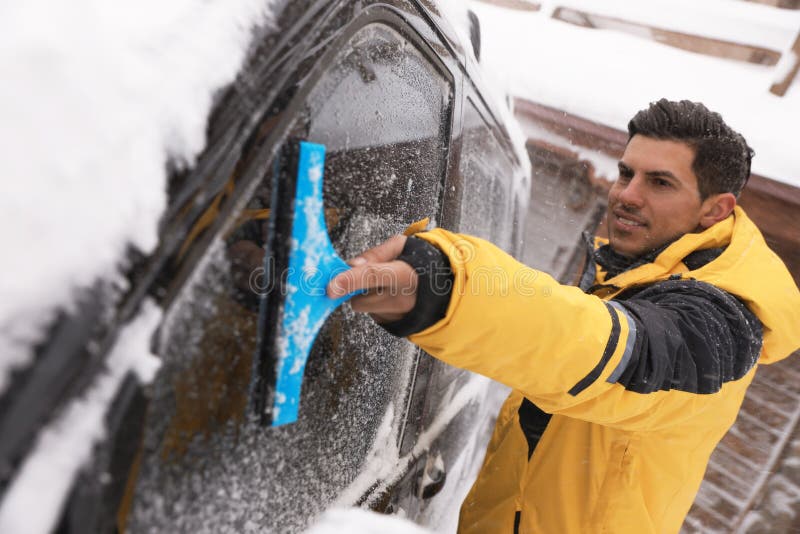 Man Cleaning Snow from Car Window on Winter Day Stock Photo - Image of ...
