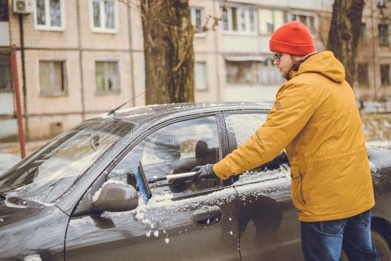 Man Cleaning Snow from Car Windshield with Brush Stock Image - Image of ...
