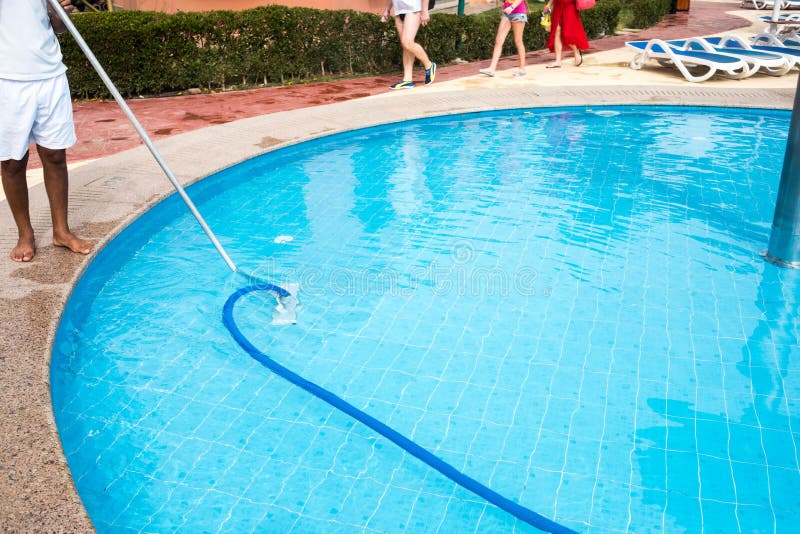 Man Cleaning a Swimming Pool in Summer. Cleaner of the Swimming Pool ...
