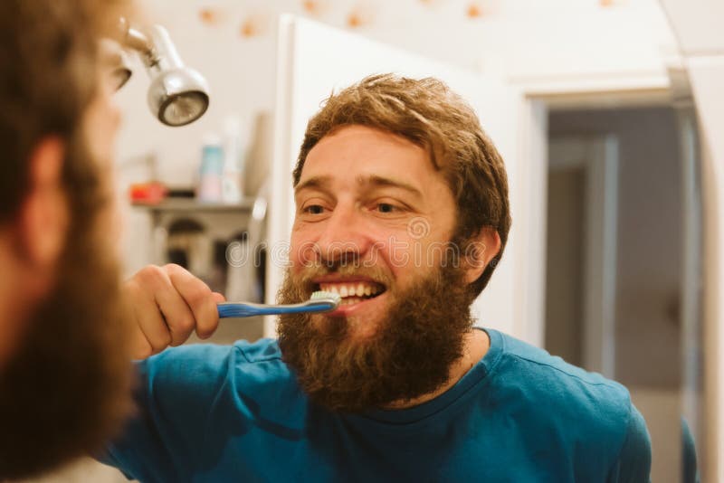 Man Cleaning Teeth in Bathroom Stock Photo - Image of adult, close ...