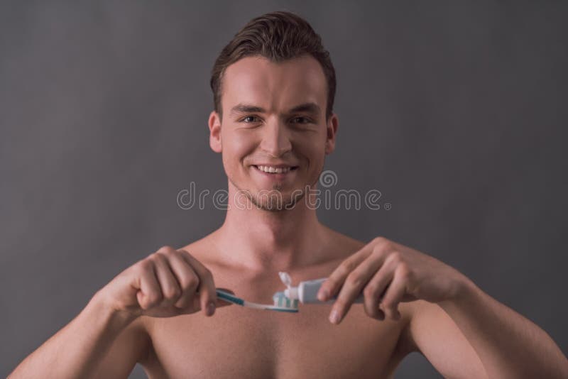 Man cleaning teeth stock photo. Image of beauty, adult - 118097400