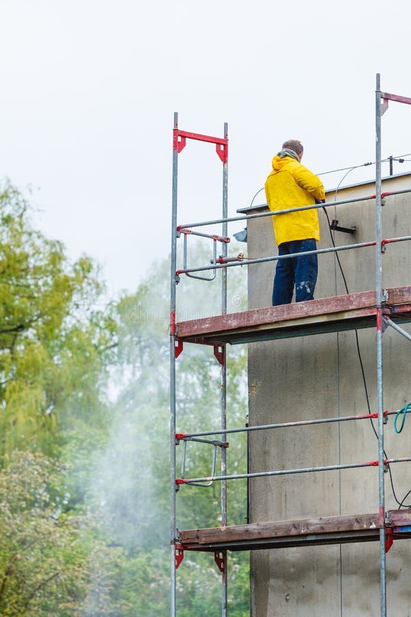 Man Cleaning Wall. Scaffolding Stock Image - Image of technology ...