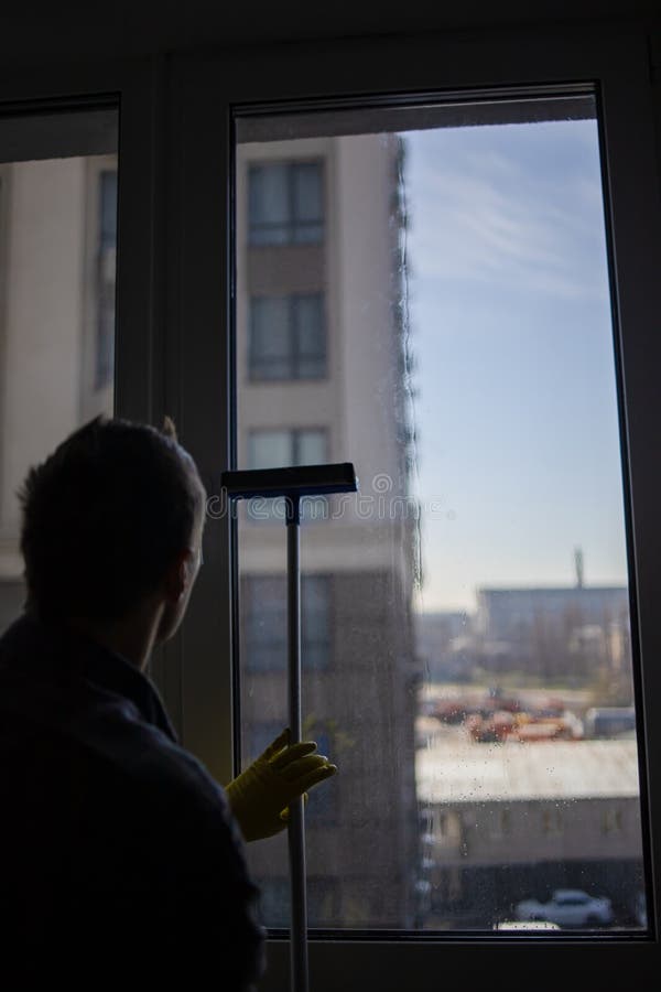 Man Cleaning Window at Home. a Worker Washes Windows in Office. Window ...