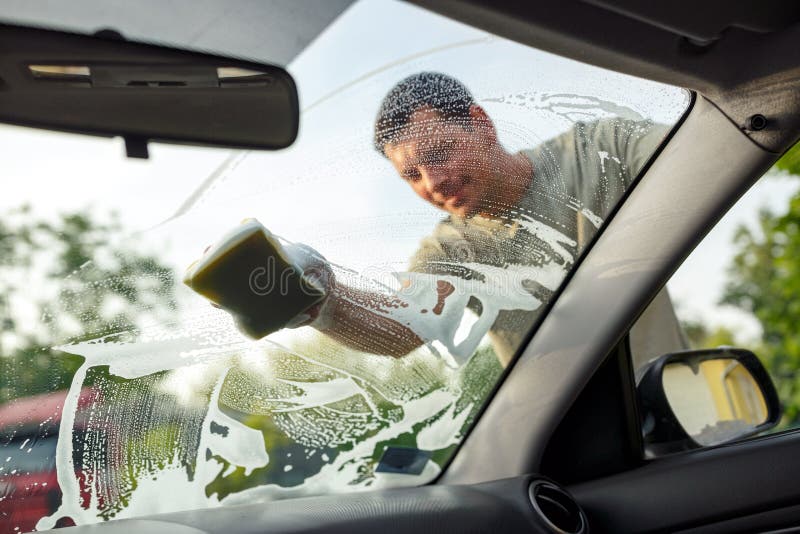 Man is Cleaning Windows of a Car with a Sponge and Foam Stock Photo ...
